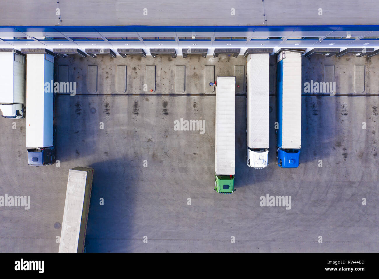 Aerial drone view on logistics center with trucks at the loading bays ...