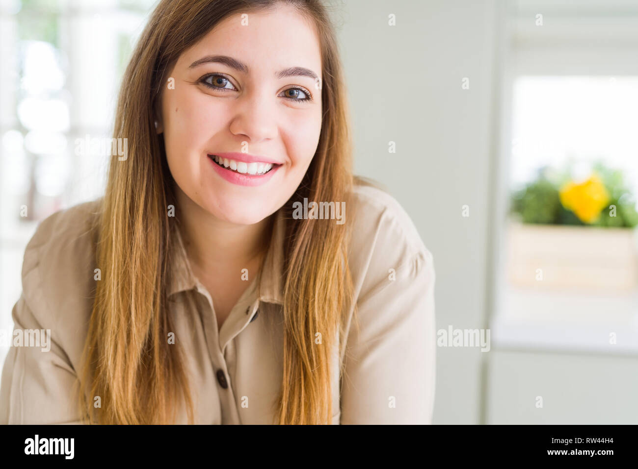 Beautiful young woman at home with a happy and cool smile on face ...