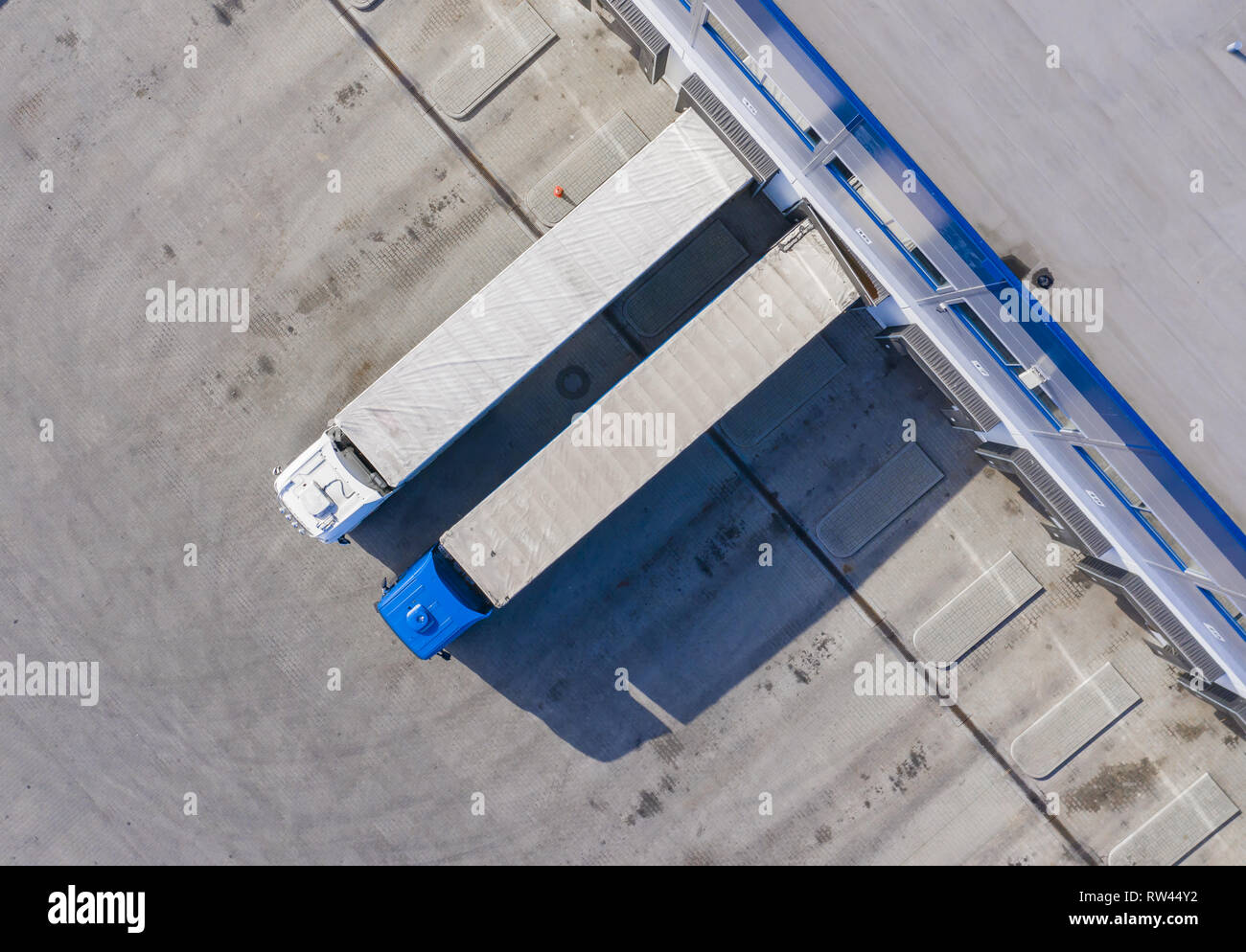Logistics center. Trucks in warehouse distribution center. Aerial View ...