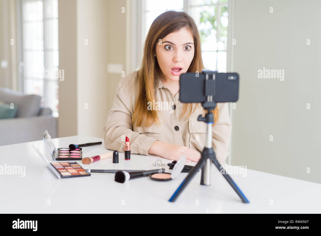 Beautiful young influencer woman recording make up video tutorial ...