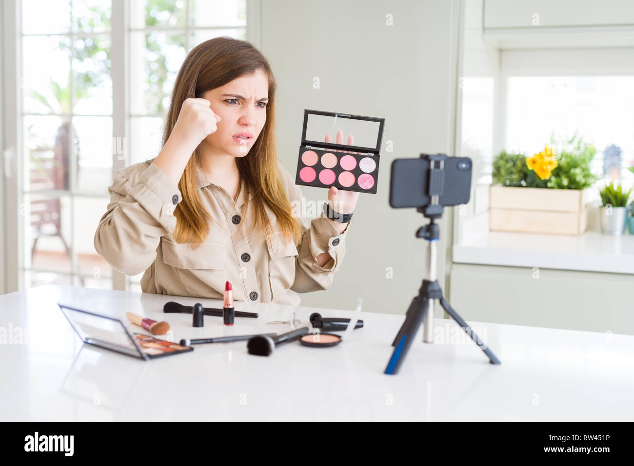 Beautiful young influencer woman recording make up video tutorial ...