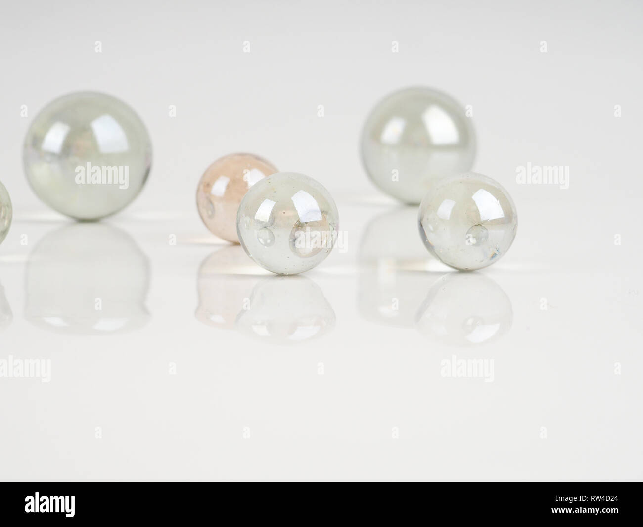 Glass marbles on a grey surface. beautiful reflection, abstract ...