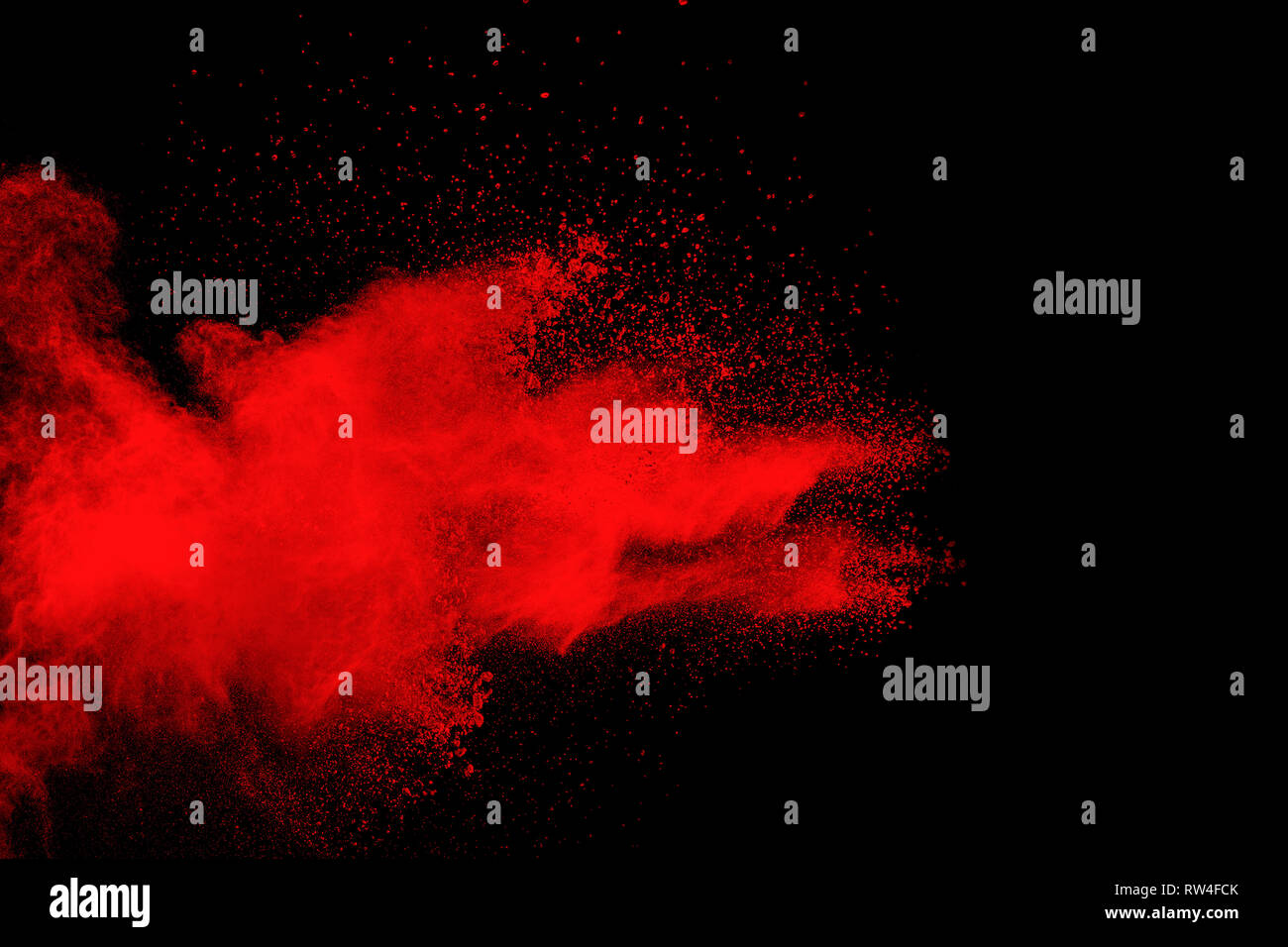 Red color powder explosion on black background.Freeze motion of red ...