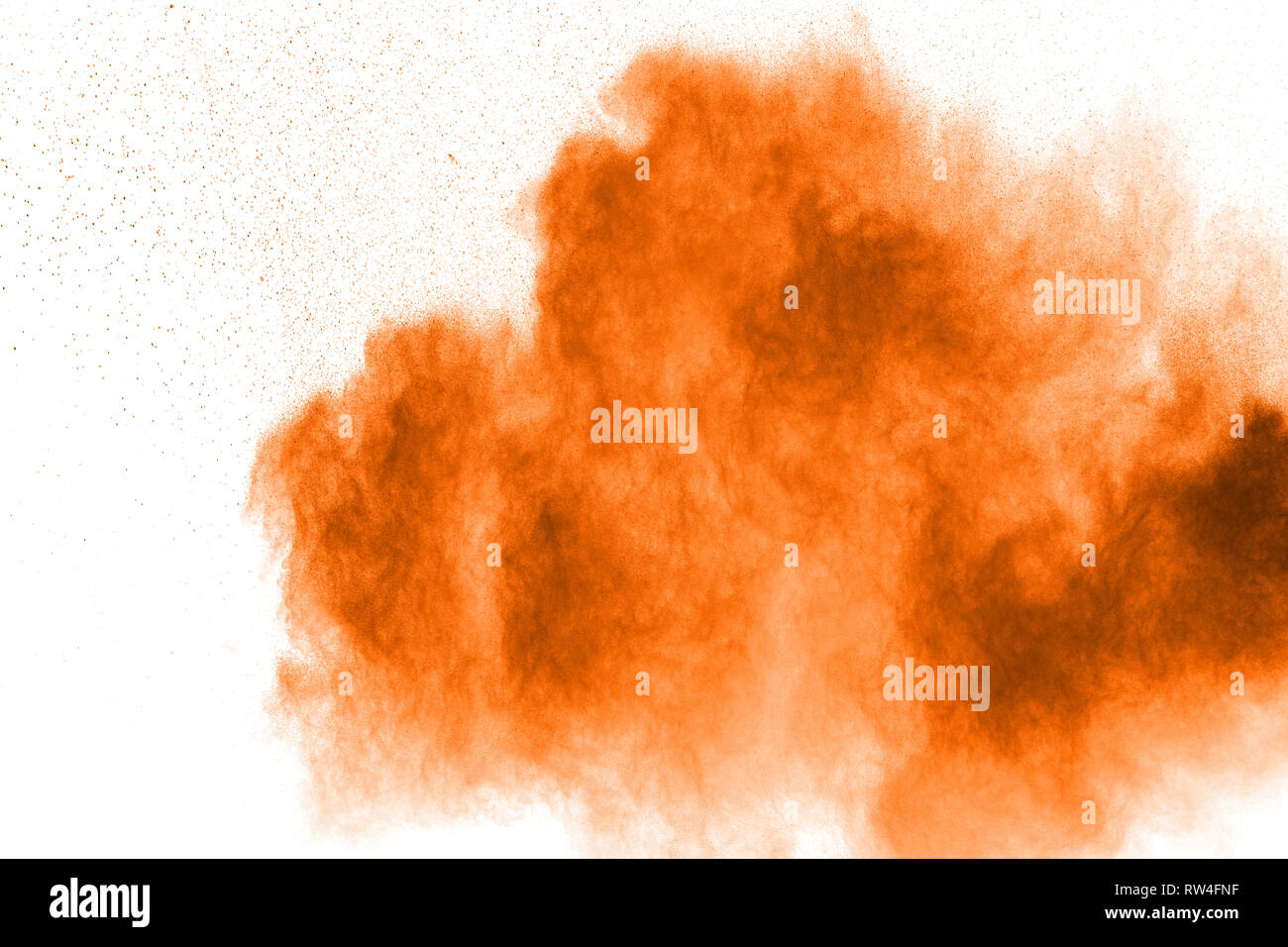 Abstract yellow orange powder explosion on white background. Freeze ...