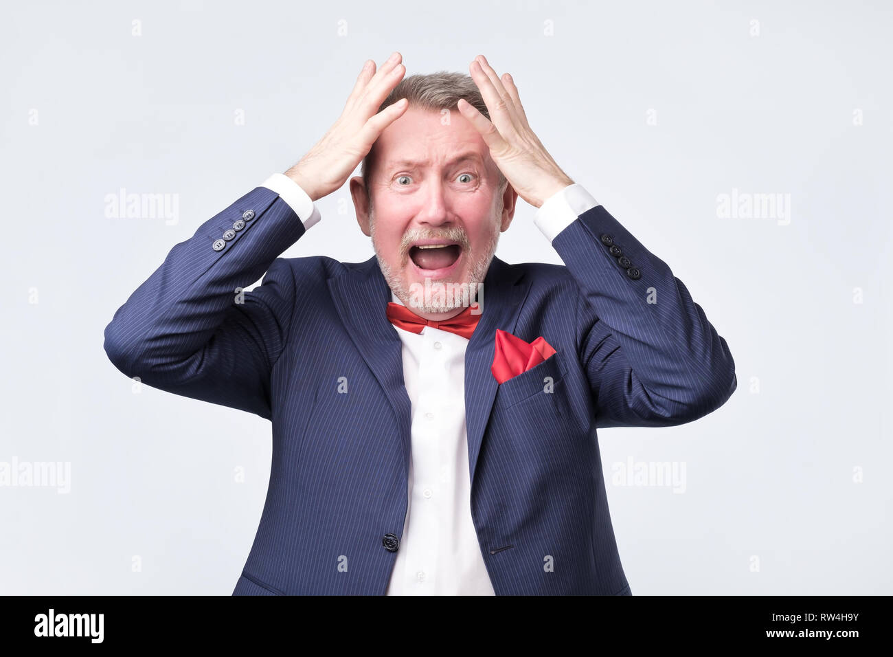 Oh no concept. Surprised, shocked man in blue suit holding hands up ...