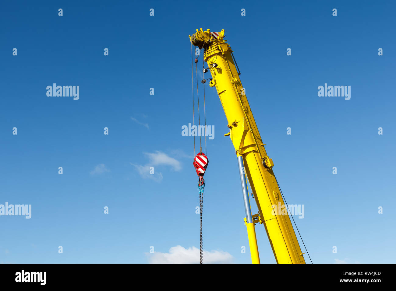 Mobile crane hook with chains, blue sky on background Stock Photo - Alamy