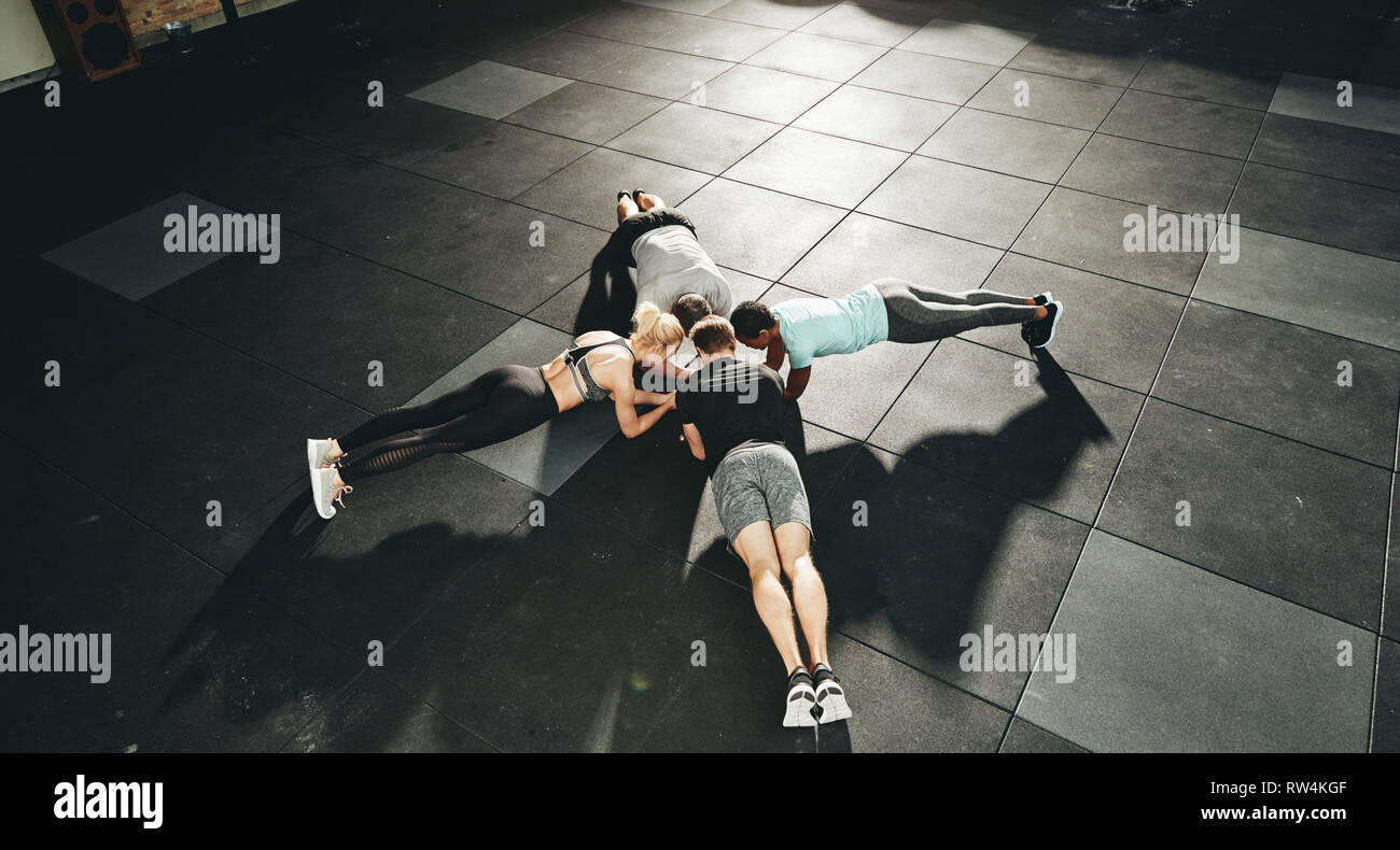 High angle of a fit group of diverse people in sportswear planking ...