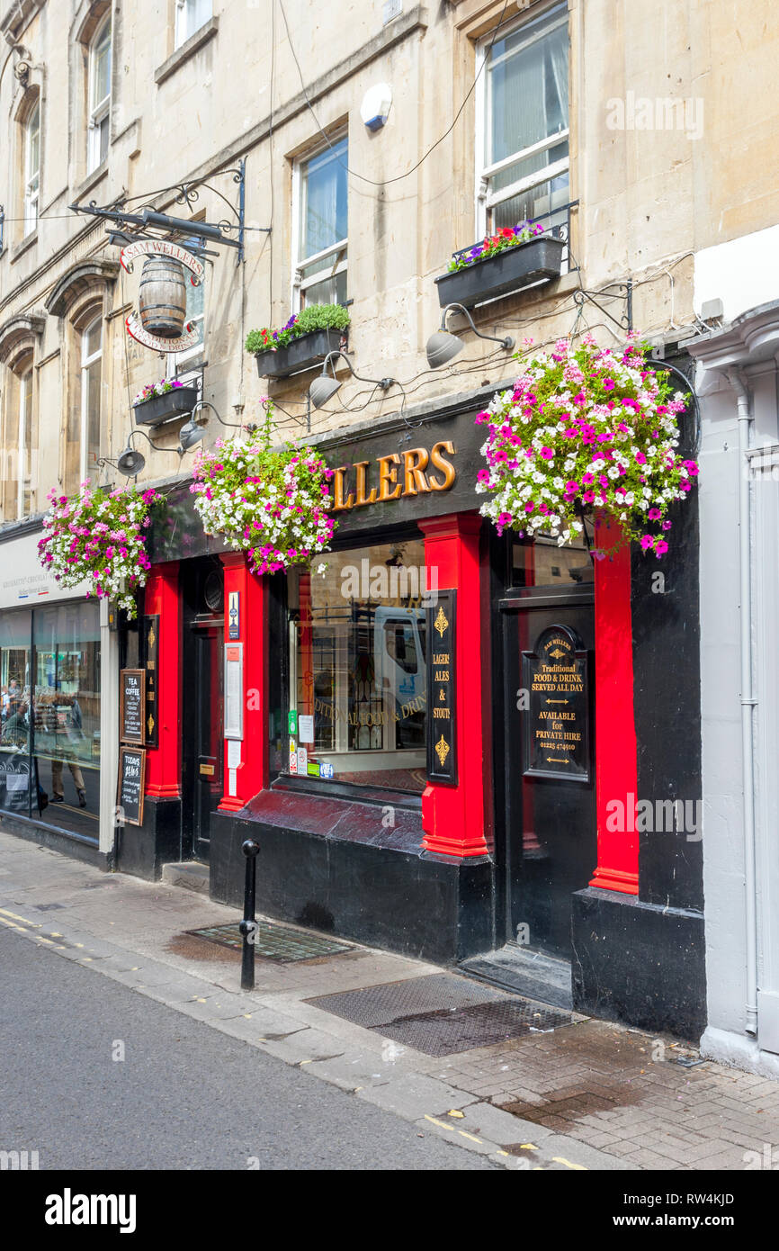 Colourful hanging baskets outside of Sam Wellers traditional English ...