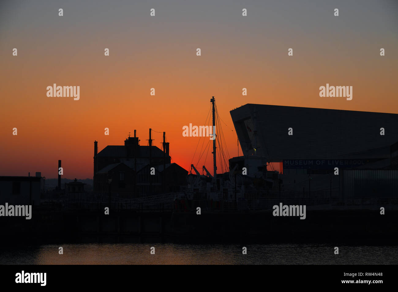 Liverpool waterfront buildings in silhouette against a sunset sky Stock ...