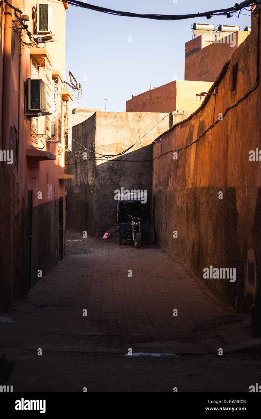 Typical picturesque small alley in the souks of the Medina of Marrakesh ...