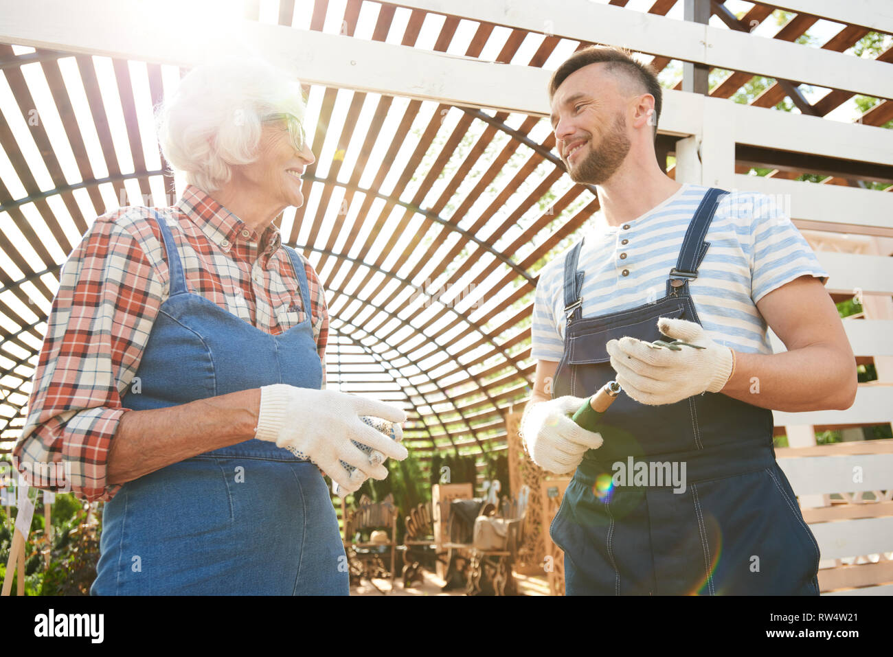 Two Smiling Gardeners in Sunlight Stock Photo - Alamy