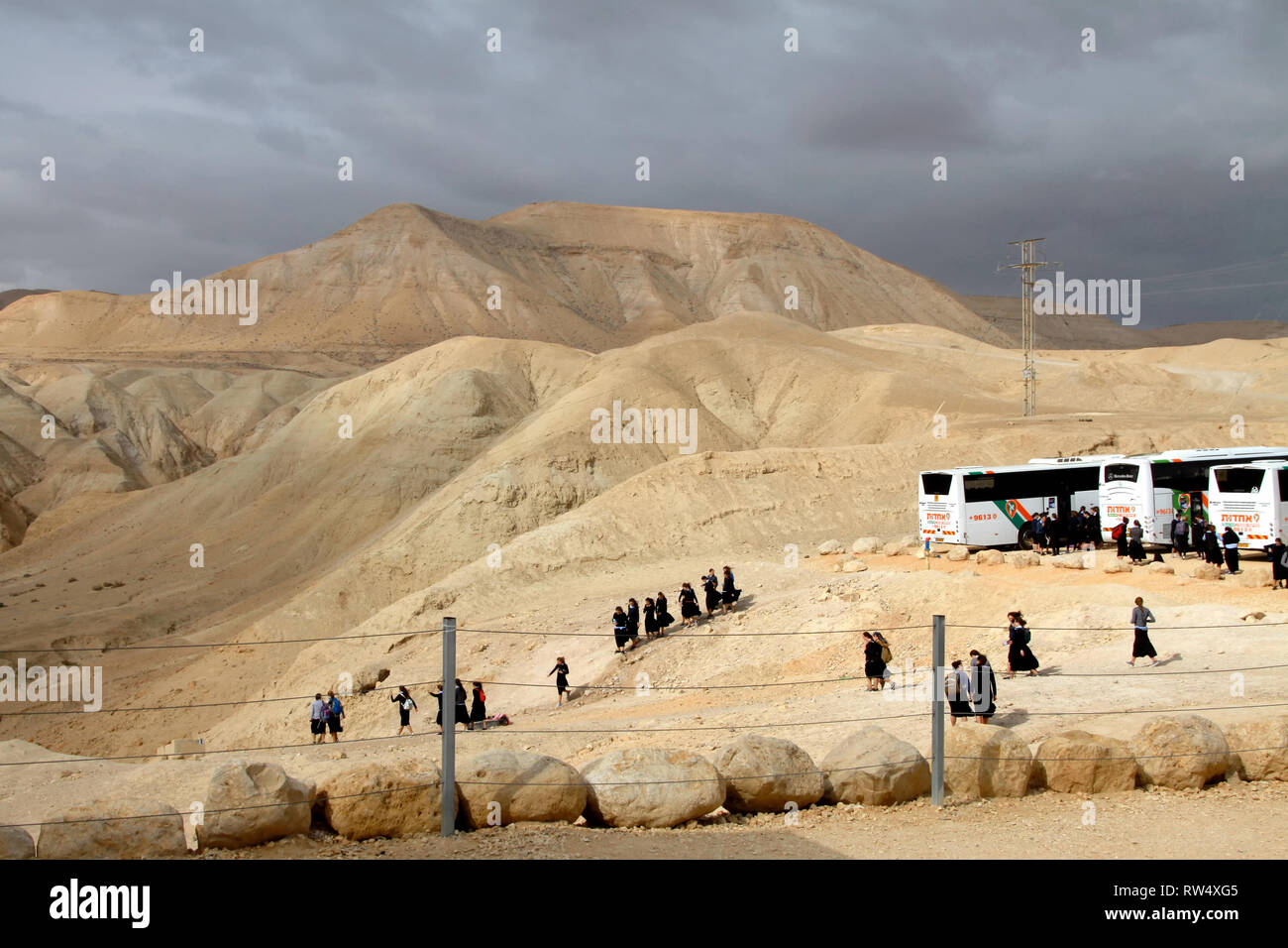 A group of Jewish school girls explore the desert near the Dead Sea in ...
