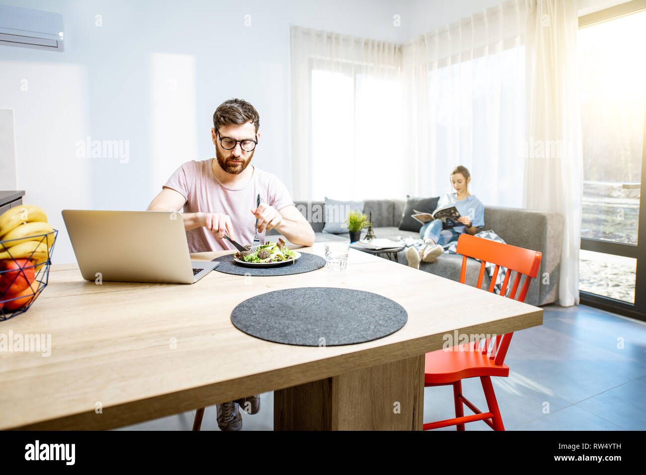 Man eating and working with laptop hi-res stock photography and images ...