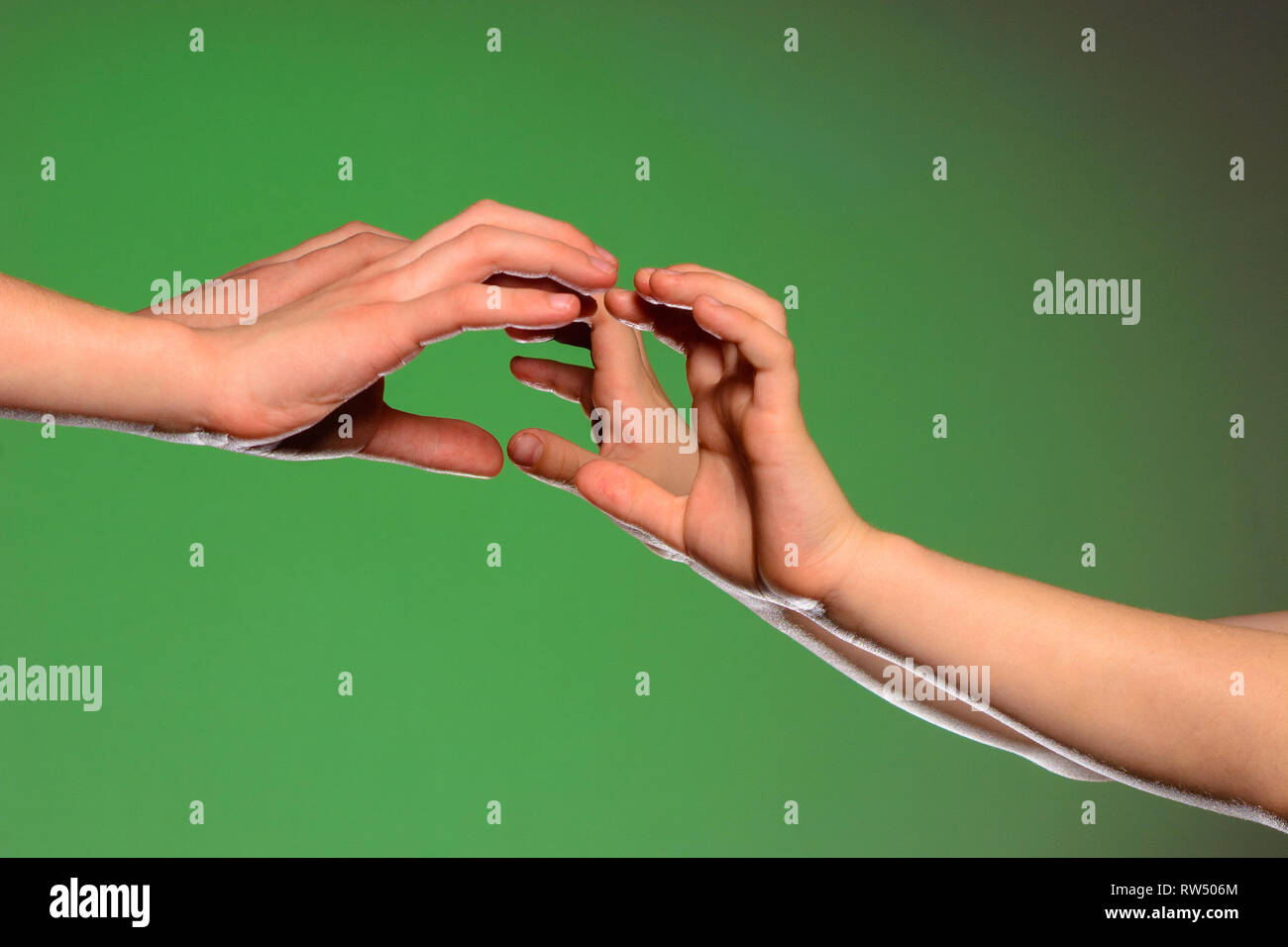 Two hands stretch to each other from the opposite sides symbolizing the ...