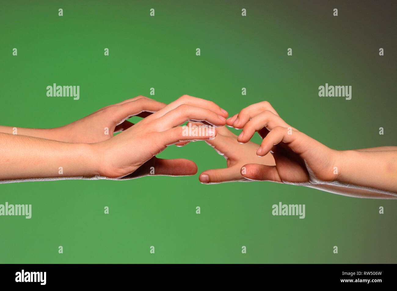 Two hands stretch to each other from the opposite sides symbolizing the ...