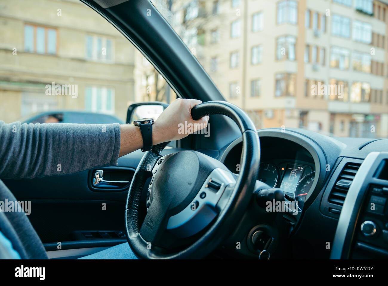 man driving car by city streets. view from inside Stock Photo - Alamy