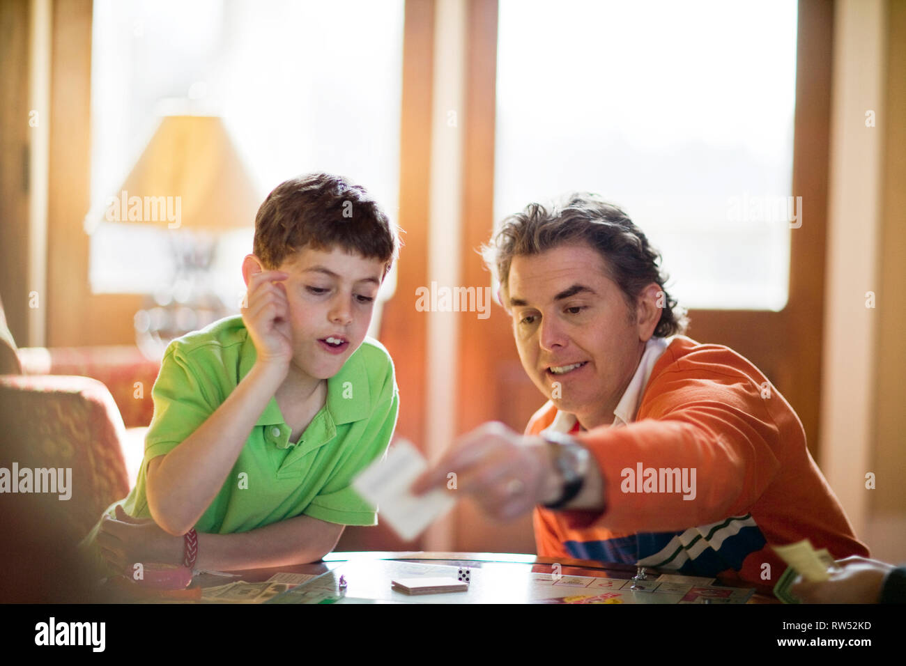 Father and son playing monopoly Stock Photo - Alamy