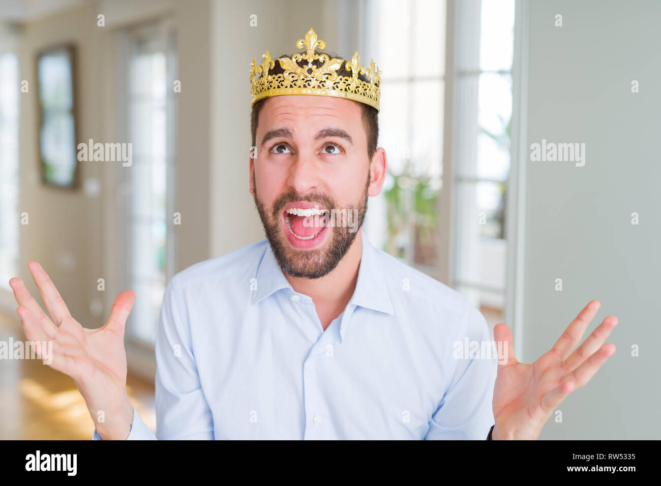 Handsome business man wearing golden crown as a king or prince crazy ...