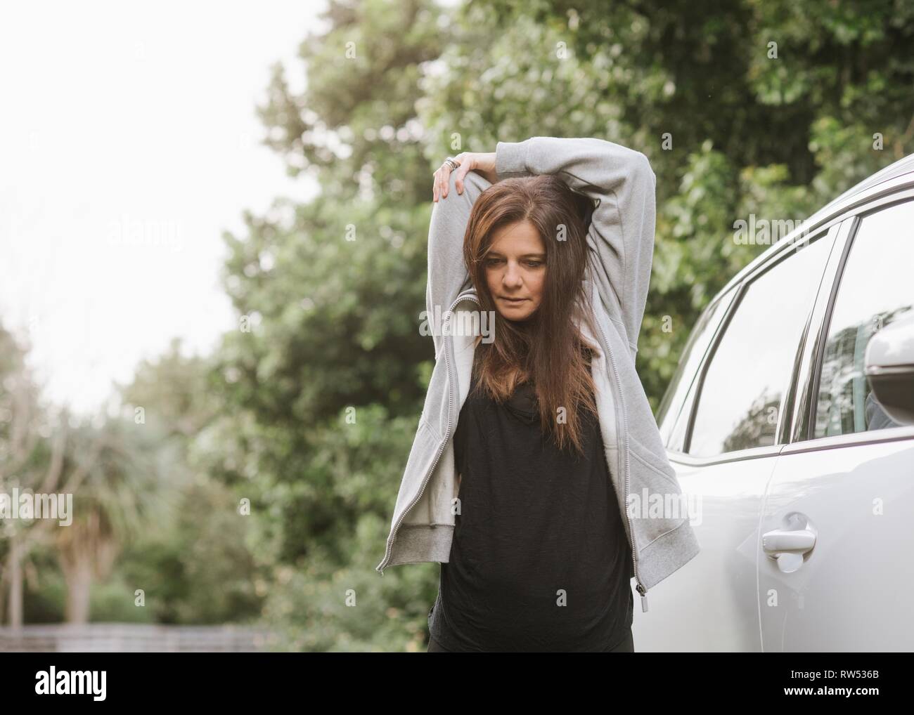 Stretching woman car hi-res stock photography and images - Alamy