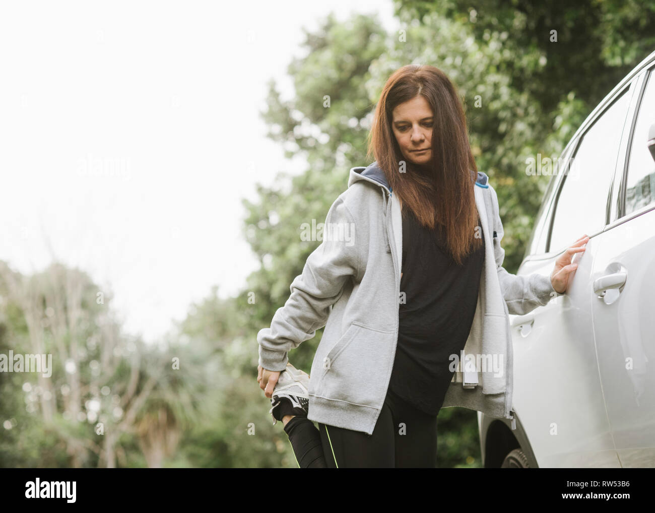 Stretching woman car hi-res stock photography and images - Alamy