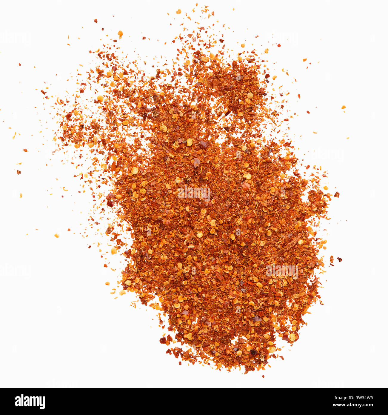 Chili pepper condiment explosion on white background Stock Photo - Alamy
