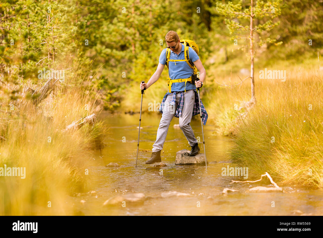 Young man crosses river hi-res stock photography and images - Alamy
