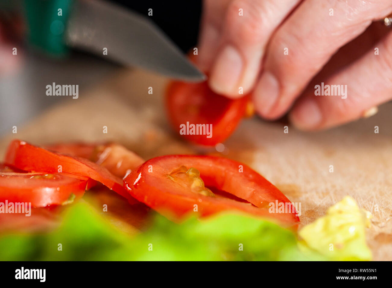 Woman Chopping Tomatoes High Resolution Stock Photography and Images ...