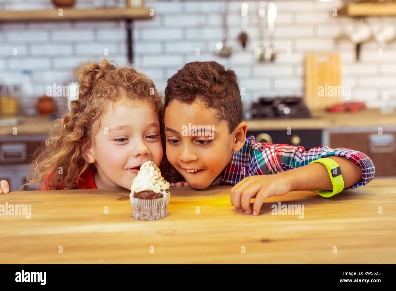 Positive delighted children dreaming to try dessert Stock Photo - Alamy
