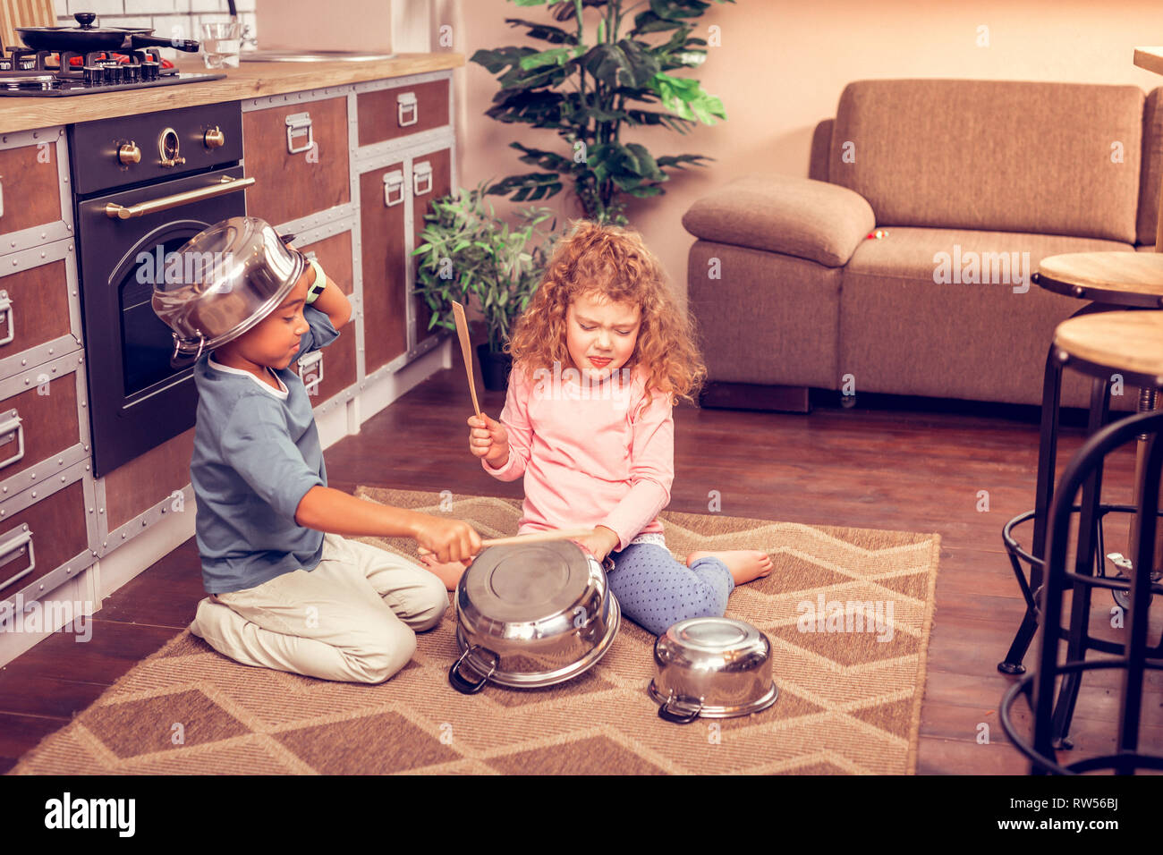 Two international best friends beating the pan Stock Photo - Alamy