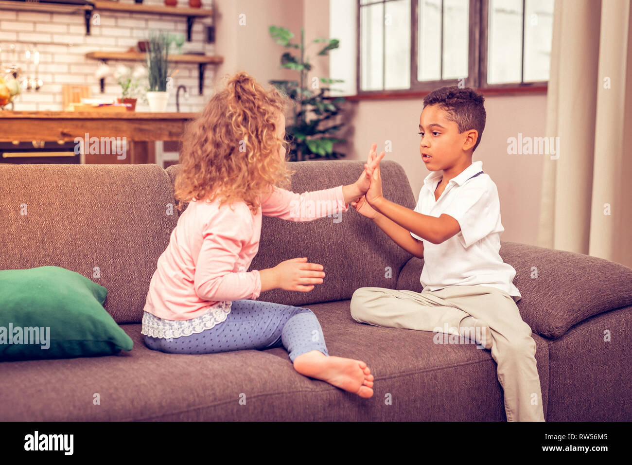 Delighted international kids clapping theirs hands during game Stock ...