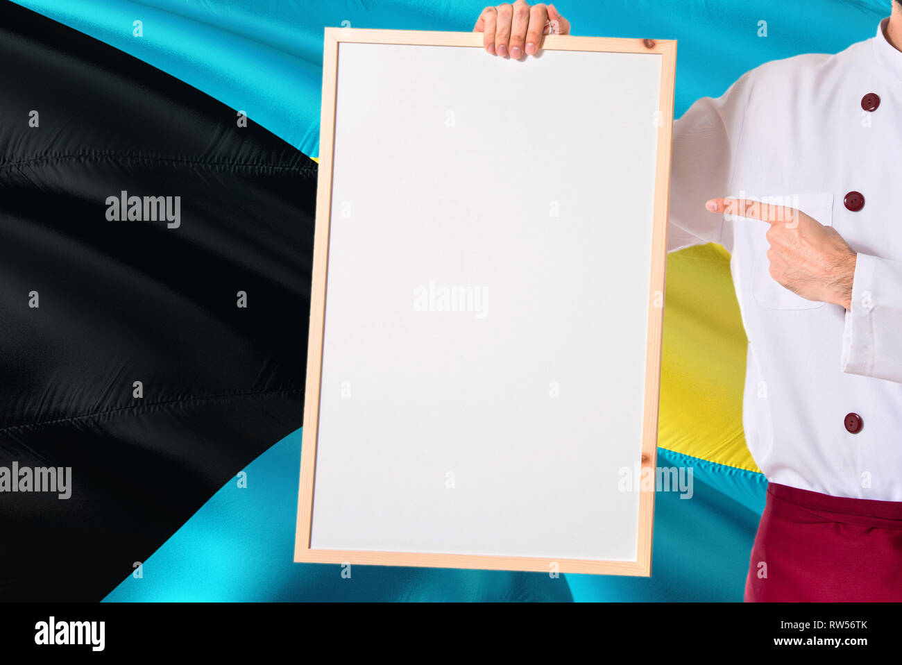 Bahamian Chef holding blank whiteboard menu on Bahamas flag background ...