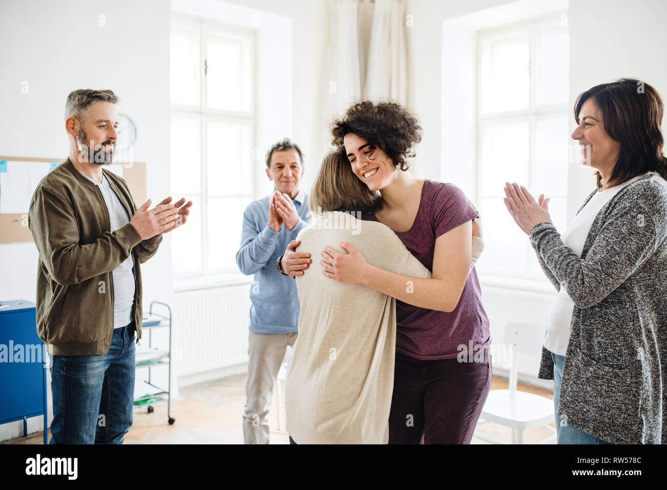 Group of men and women during group therapy, showing signs of relief ...