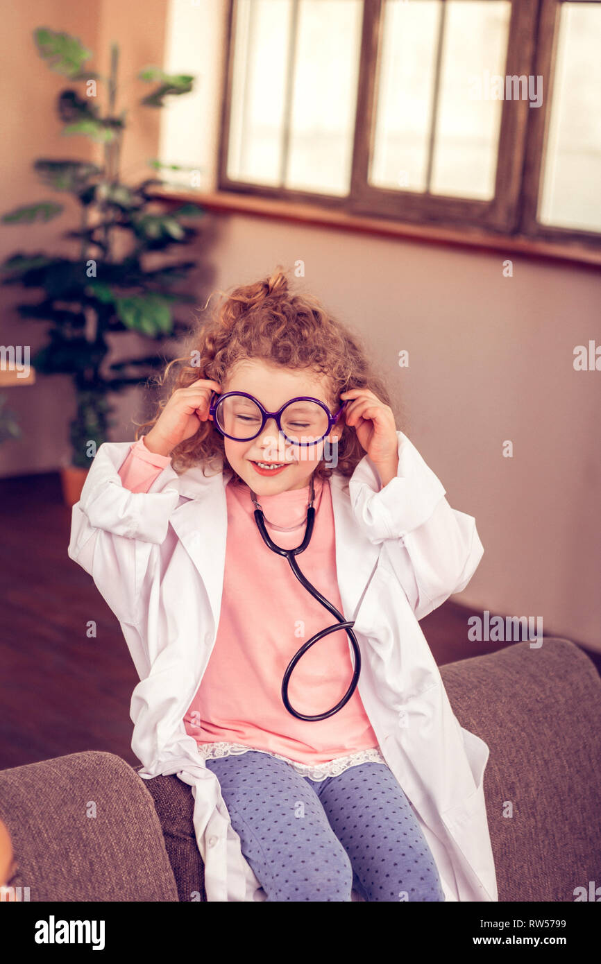 Positive delighted girl keeping smile on her face Stock Photo - Alamy