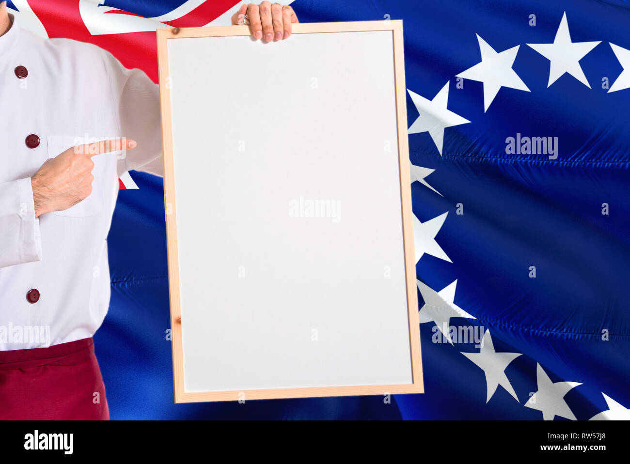 Chef holding blank whiteboard menu on Cook Islands flag background ...