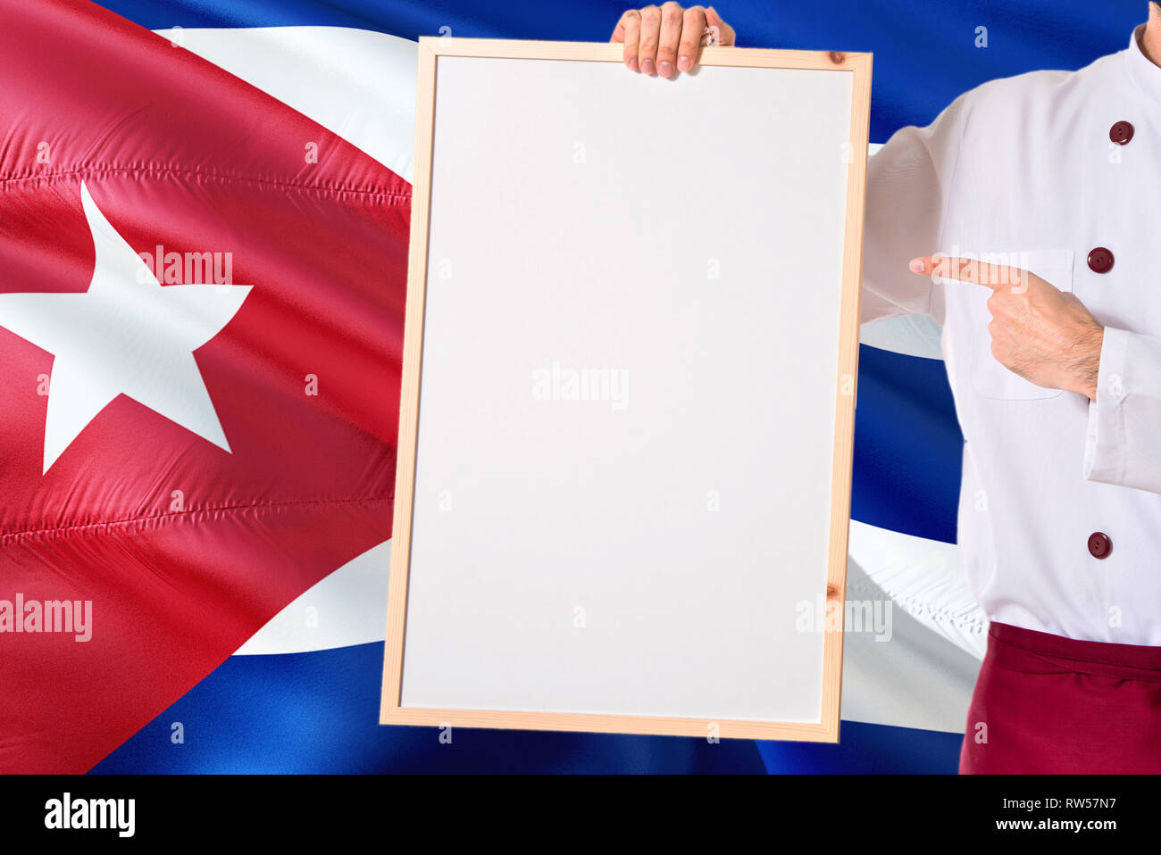 Cuban Chef holding blank whiteboard menu on Cuba flag background. Cook ...