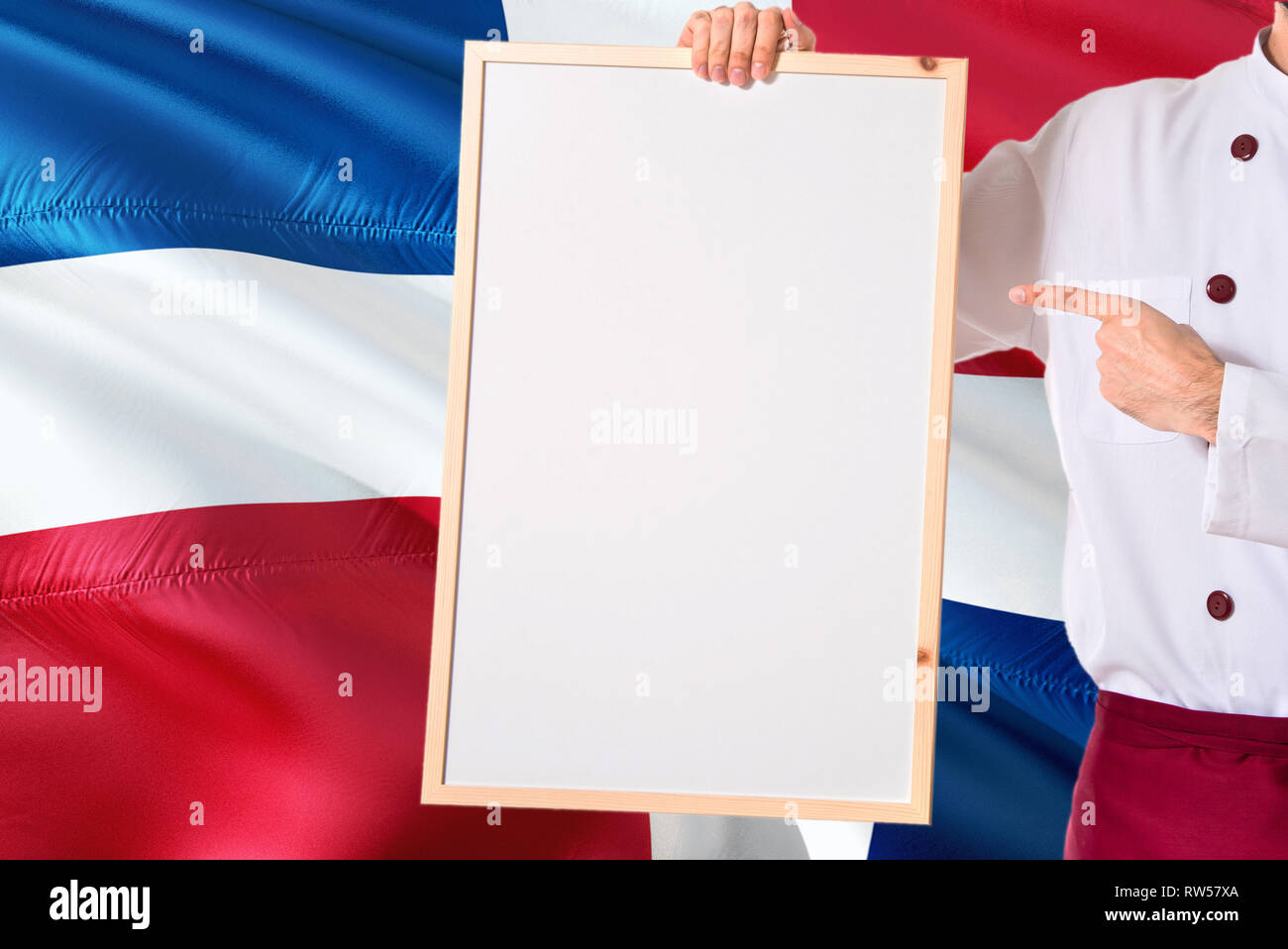 Dominican Chef holding blank whiteboard menu on Dominican Republic flag ...