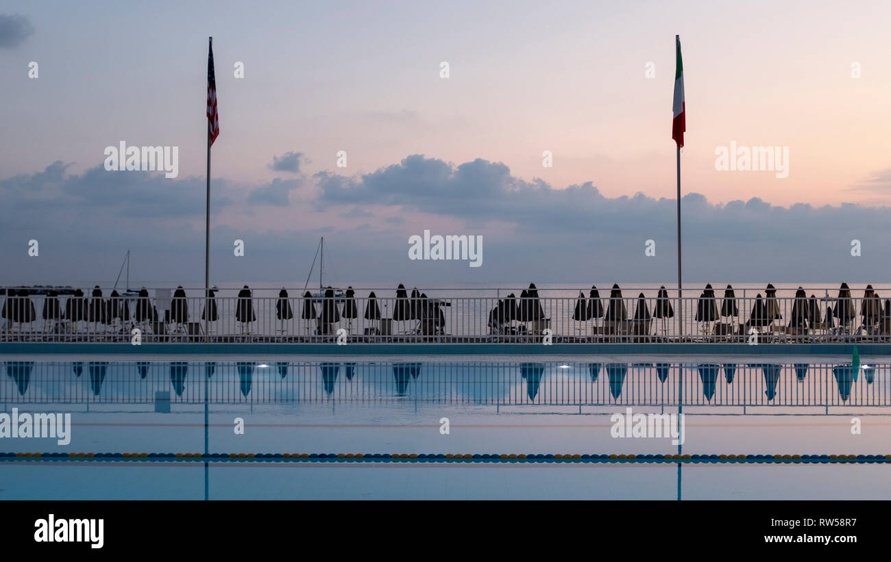 Swimming pool by a sea, evening view Stock Photo - Alamy