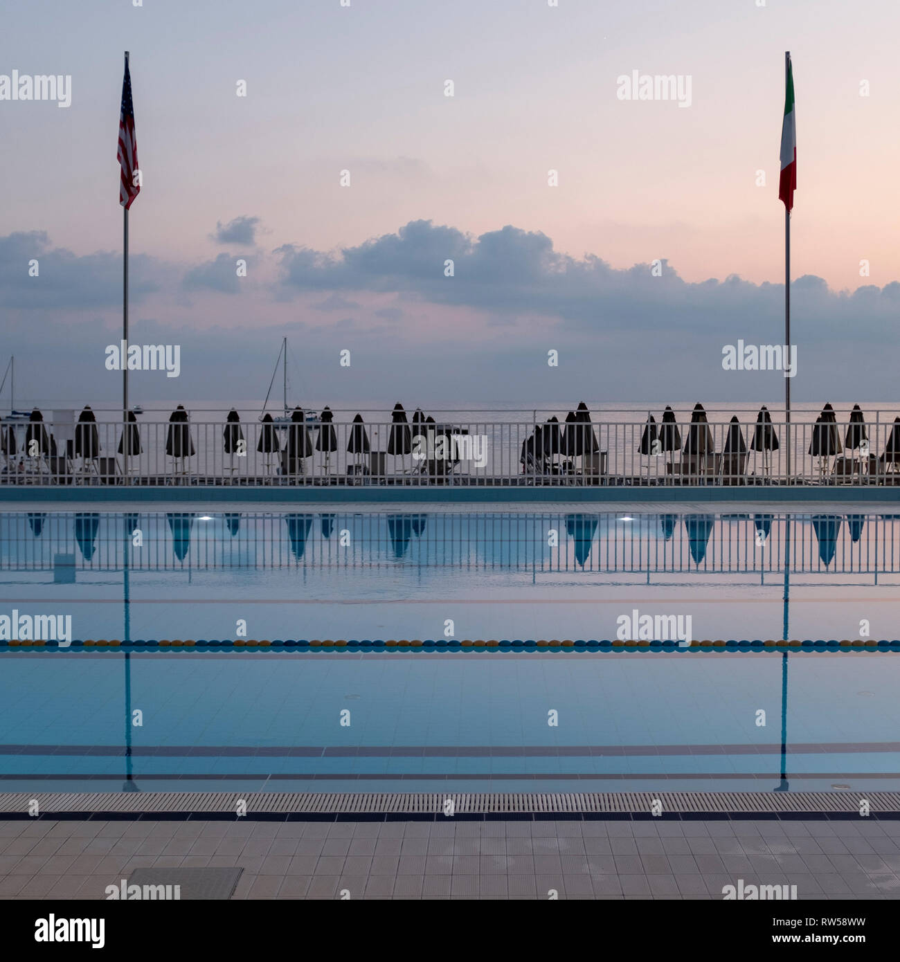 Swimming pool by a sea, evening view Stock Photo - Alamy