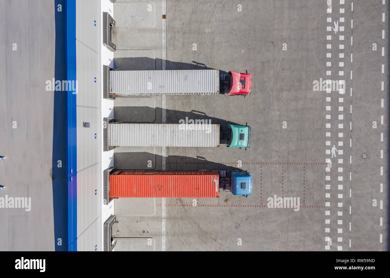 Aerial view of trucks unloading in logostics center Stock Photo - Alamy