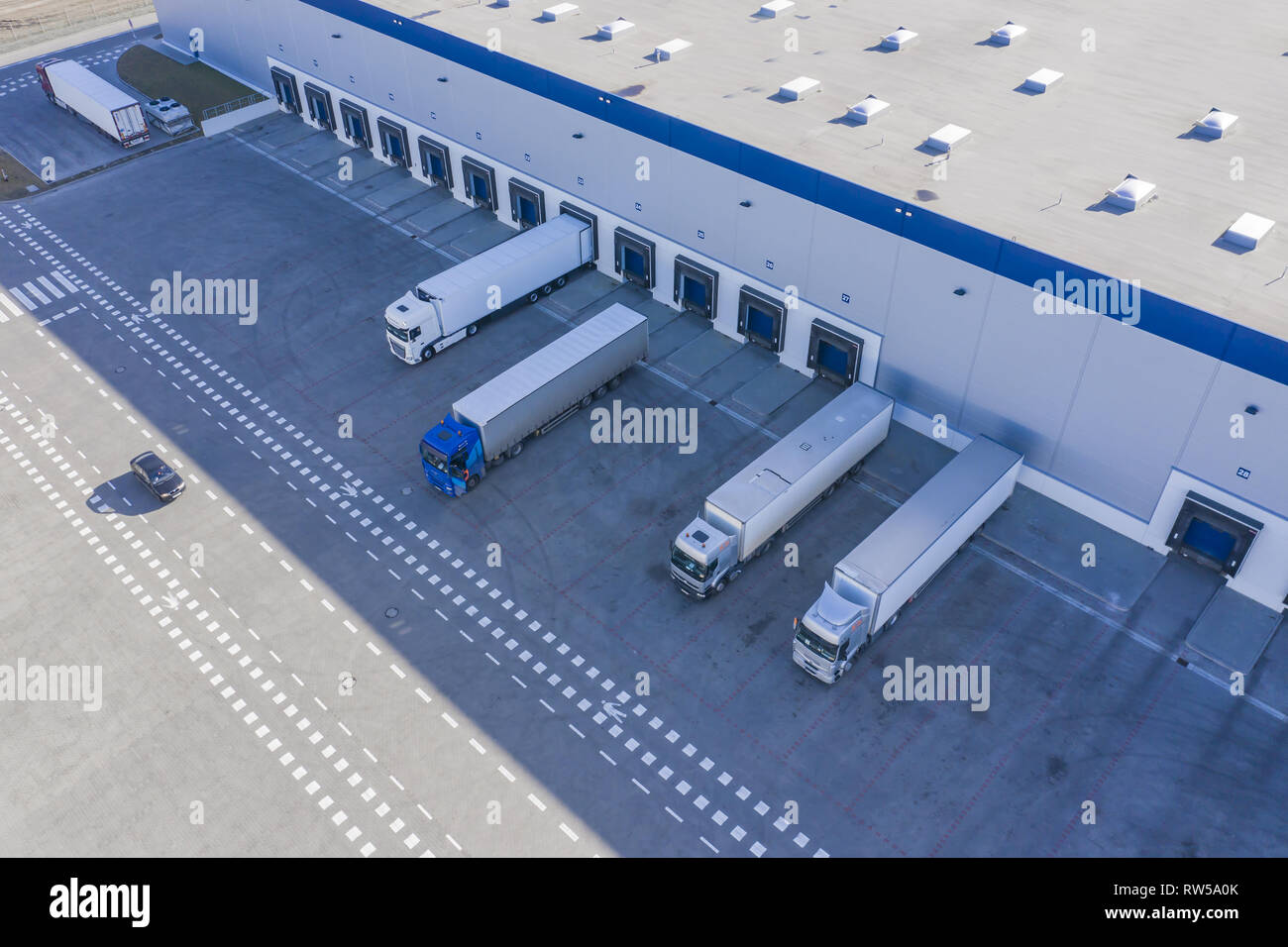 Delivering or Supply concept image. Trucks loading at facility ...