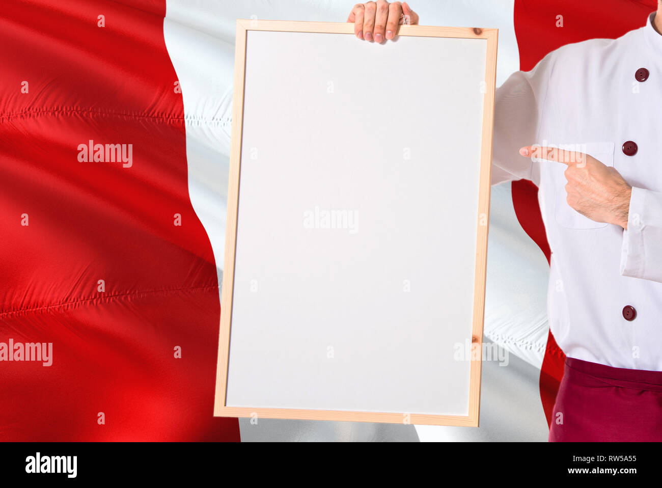 Peruvian Chef holding blank whiteboard menu on Peru flag background ...