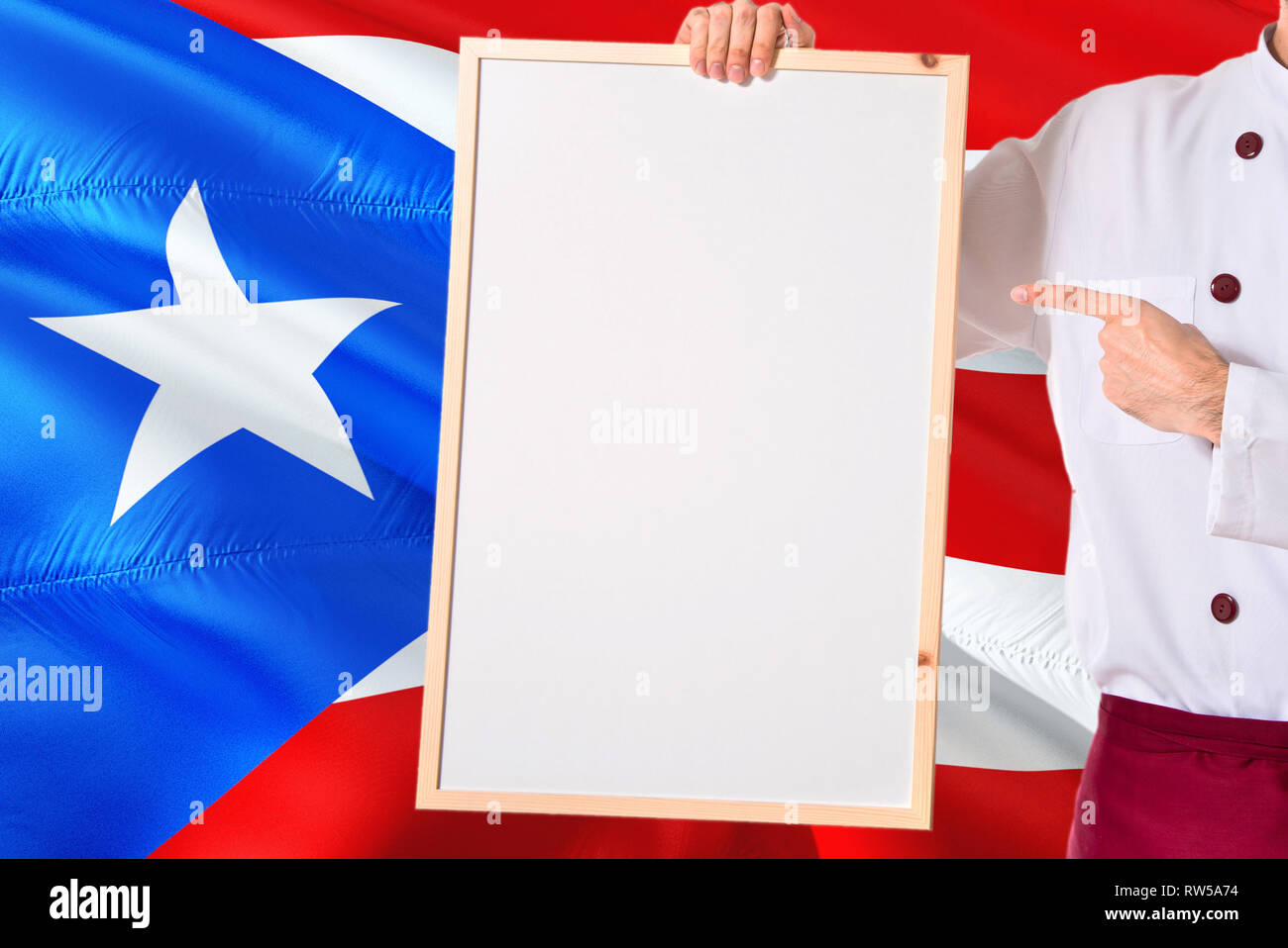 Chef holding blank whiteboard menu on Puerto Rico flag background. Cook ...