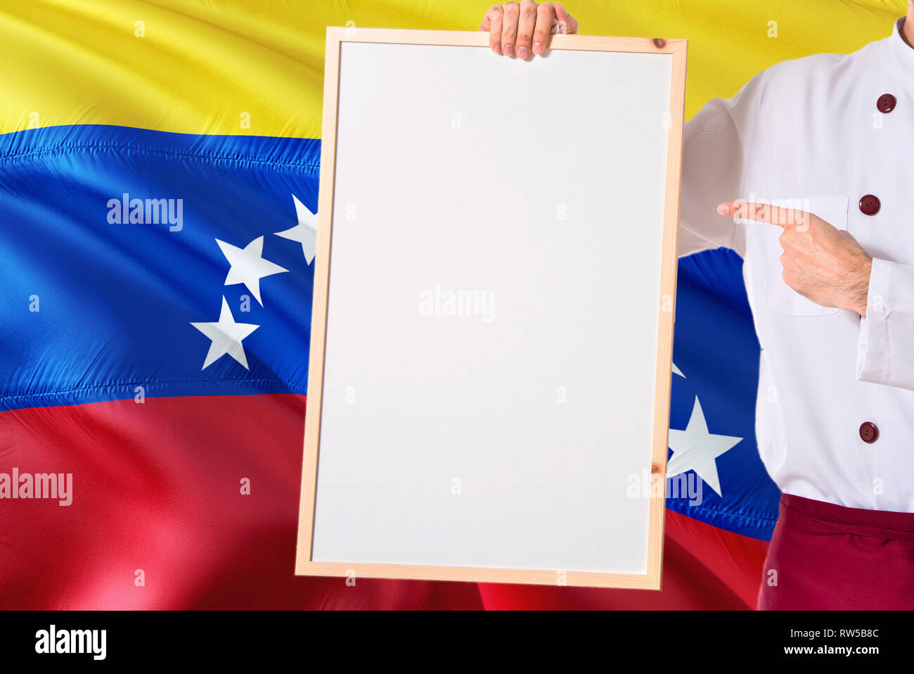 Venezuelan Chef holding blank whiteboard menu on Venezuela flag ...