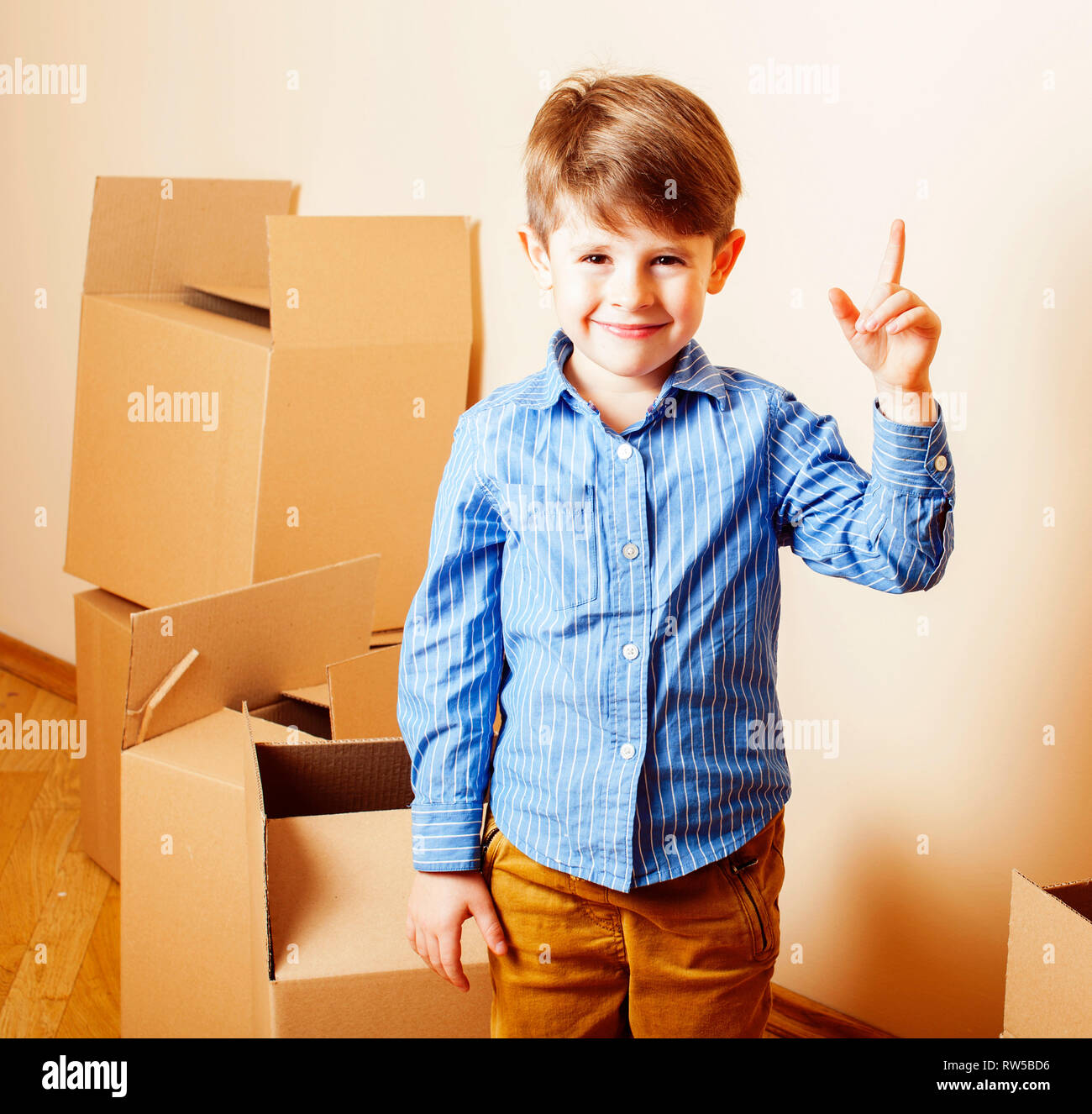 little cute boy in empty room, move to new house. home alone among ...