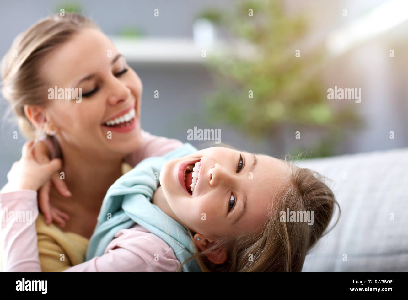 Beautiful mom and her daughter having fun at home Stock Photo - Alamy