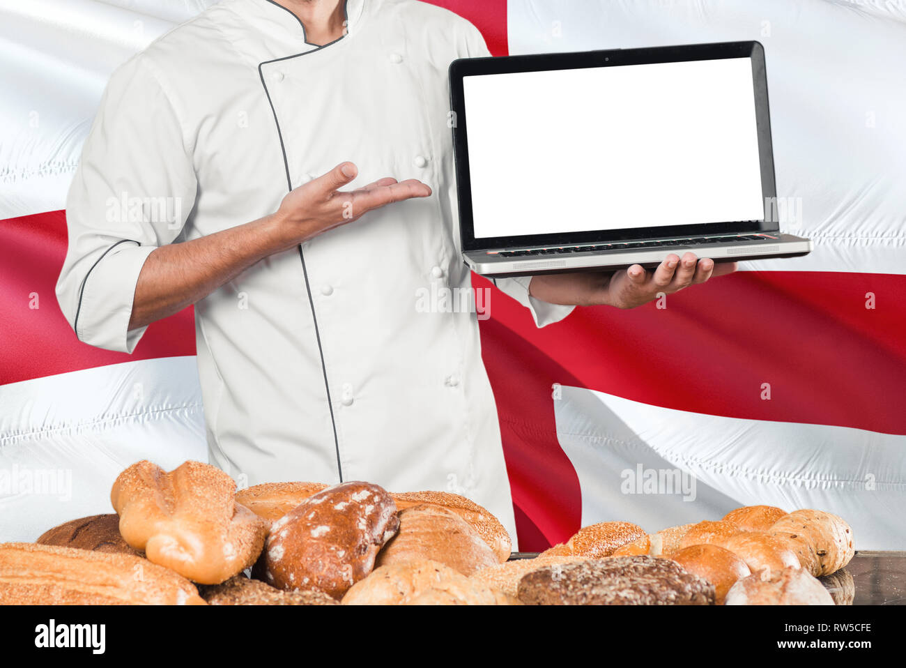 English Baker holding laptop on England flag and breads background ...