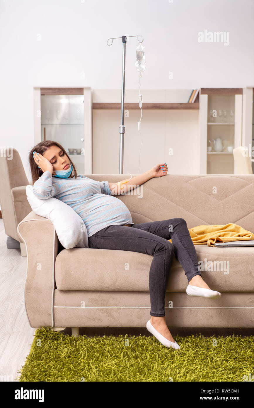 Sick pregnant woman suffering at home Stock Photo - Alamy