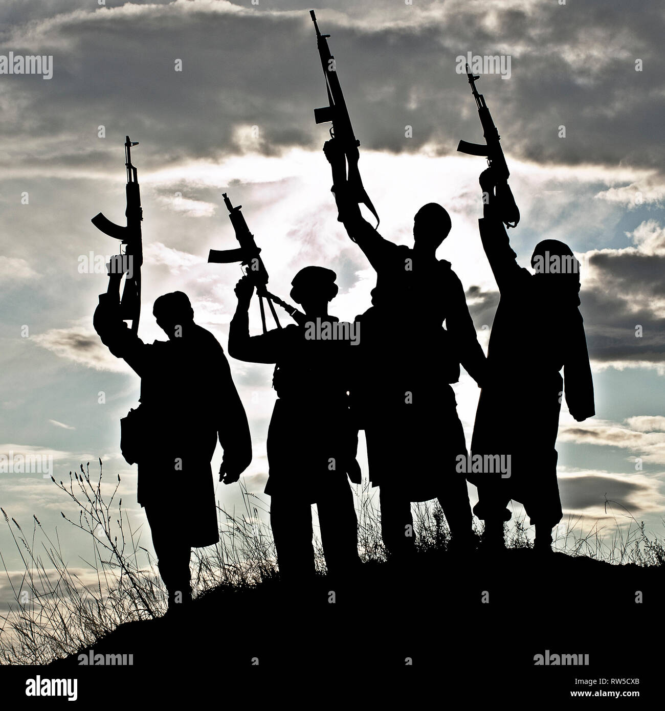 Silhouette of several muslim militants with rifles Stock Photo - Alamy