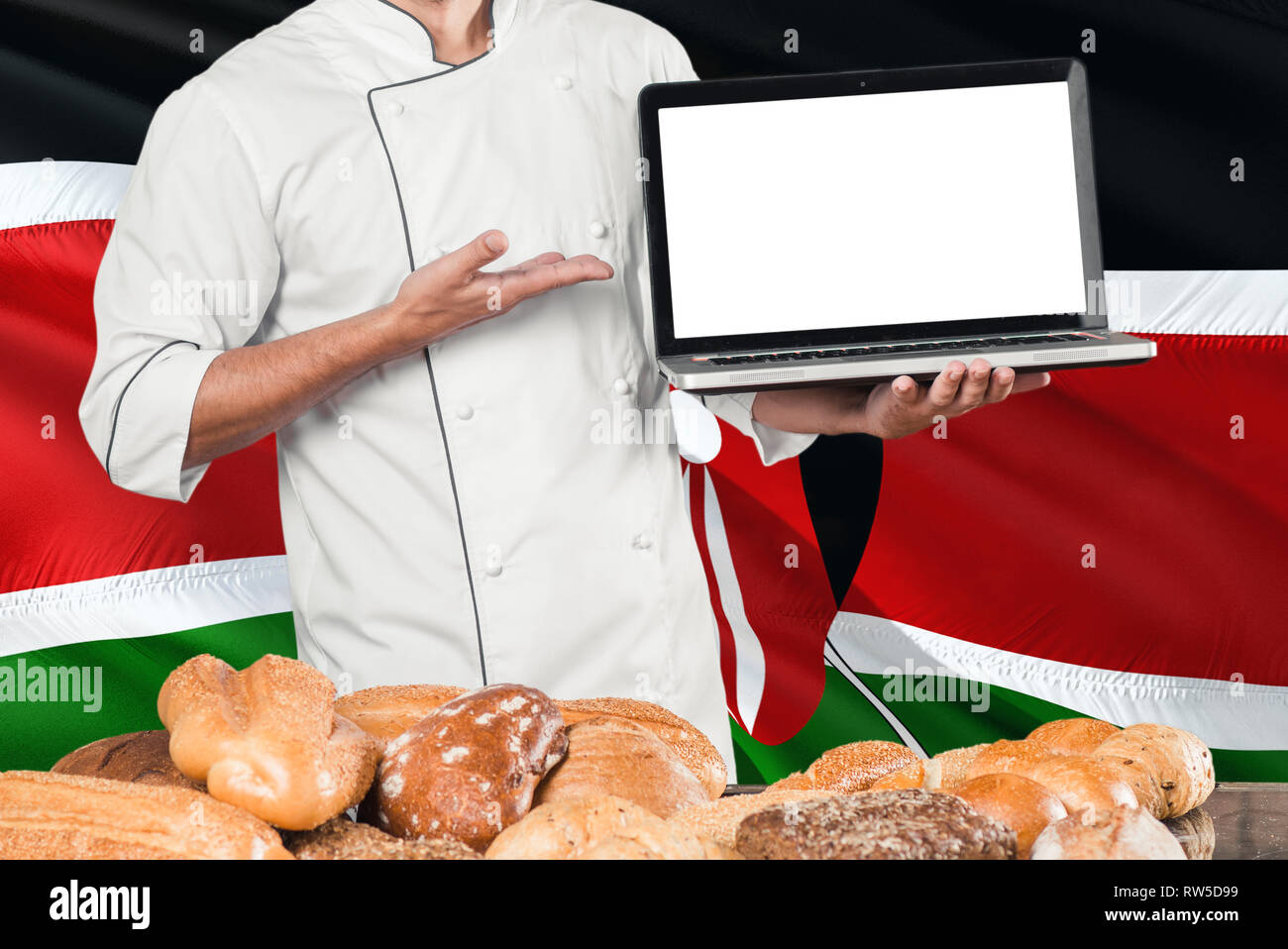 Kenyan Baker holding laptop on Kenya flag and breads background. Chef ...