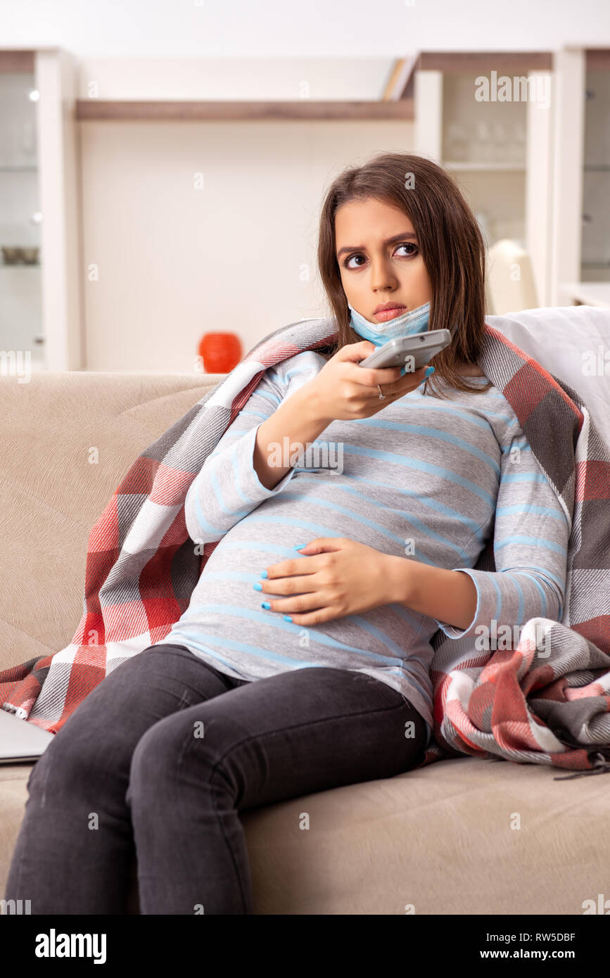 Sick pregnant woman suffering at home Stock Photo - Alamy